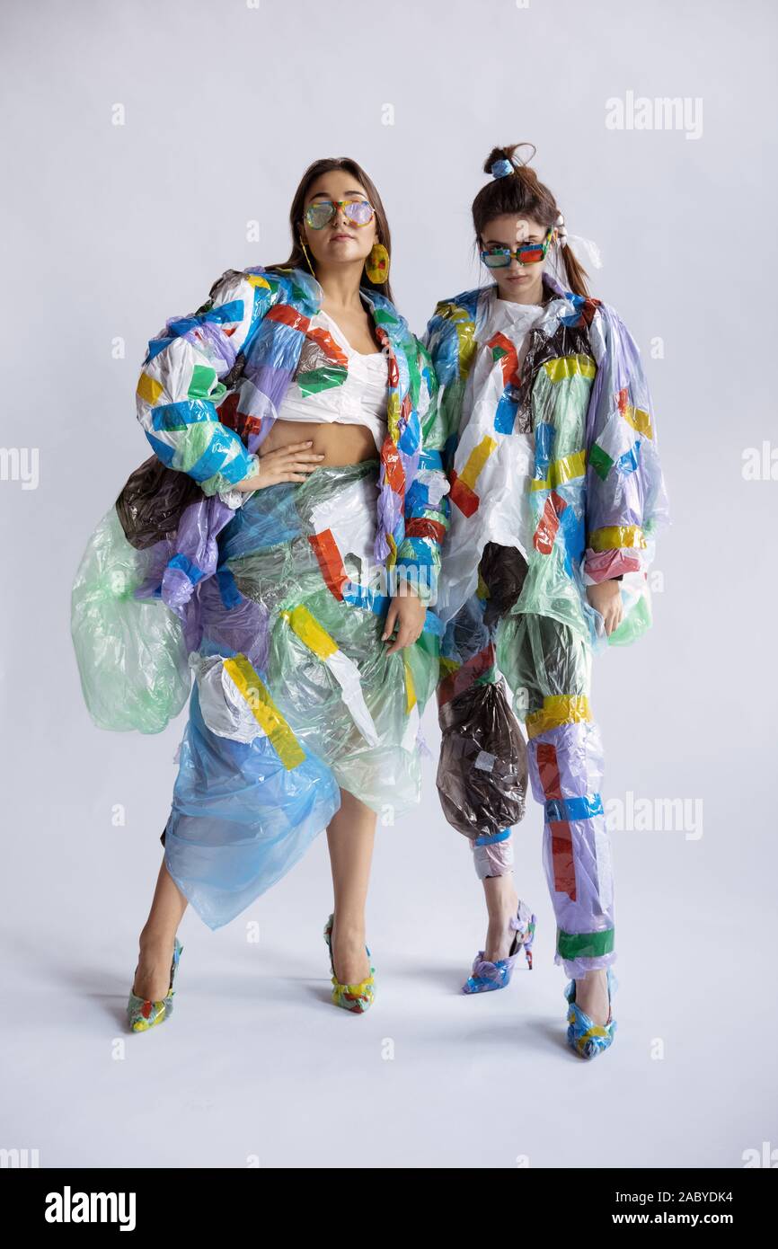 Women wearing plastic on white background. Female model in clothes and ...