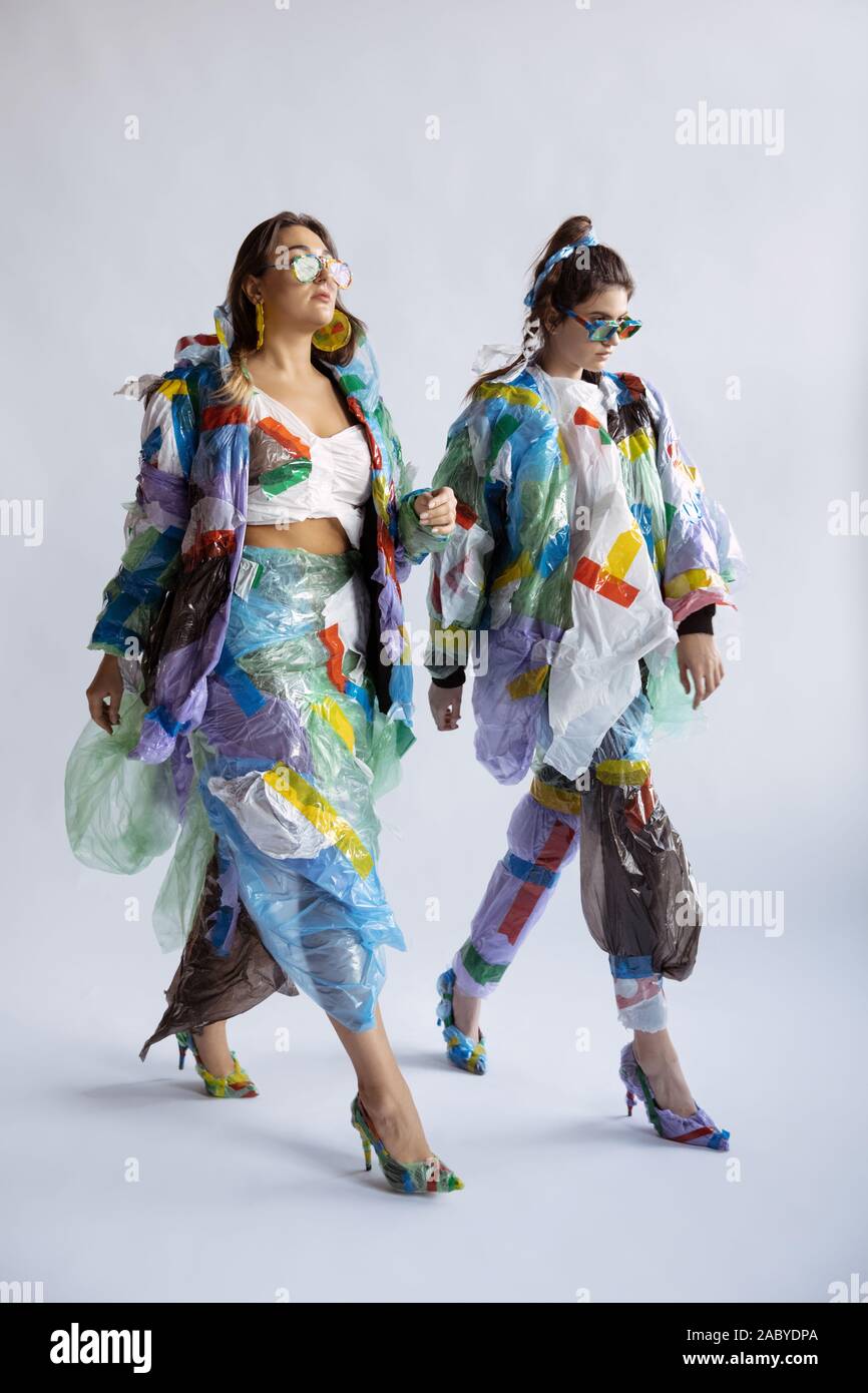 Women wearing plastic on white background. Female model in clothes and ...