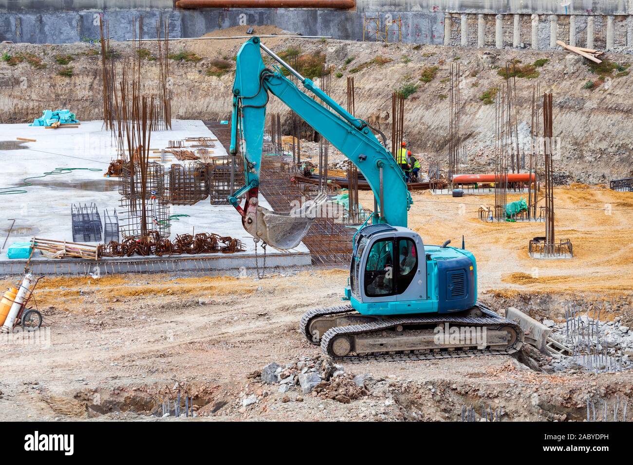 Excavator and concrete floor slab for construction of the building ...