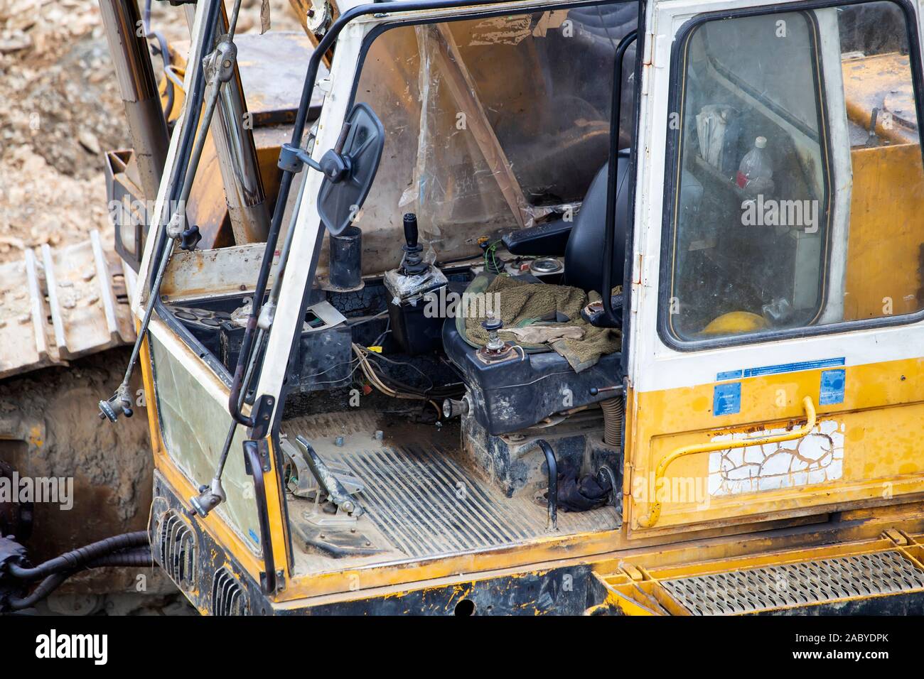 Empty cabin of a old excavator at construction site. Control system in ...