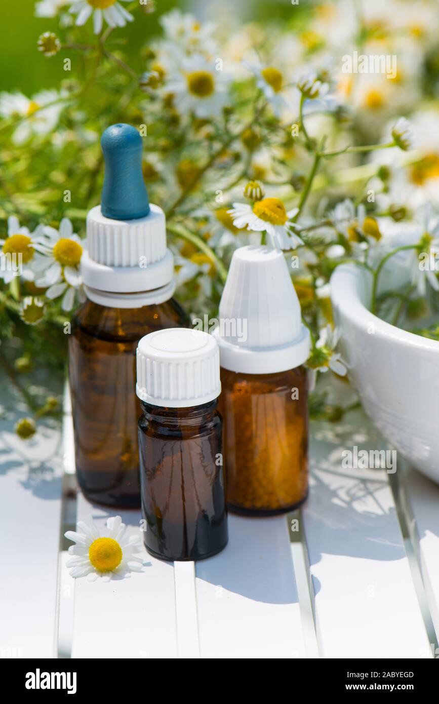 homeopathy medicine with chamomile flowers Stock Photo - Alamy
