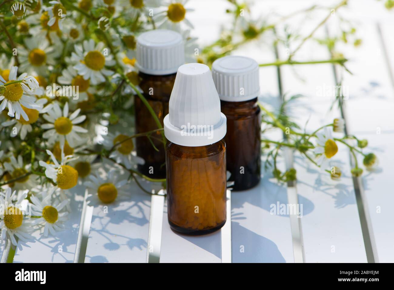 homeopathy medicine with chamomile flowers Stock Photo - Alamy