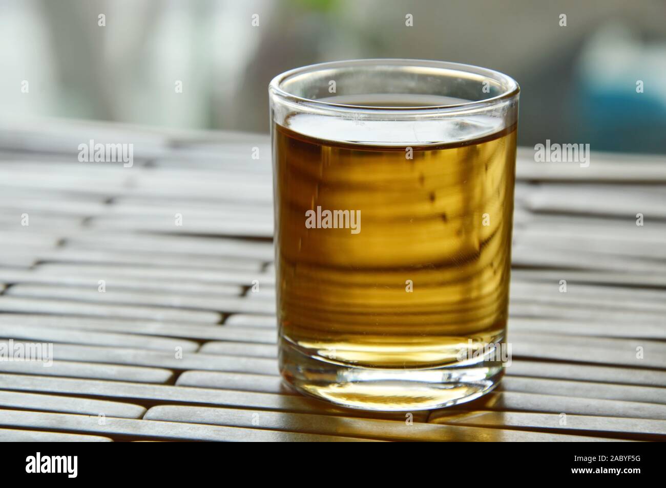 hot tea in little glass on bamboo plate Stock Photo - Alamy