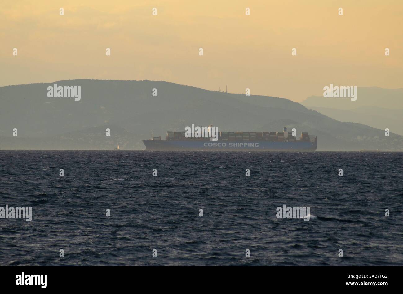 A large Cosco container ship departs from the Port of Pireaus Athens ...