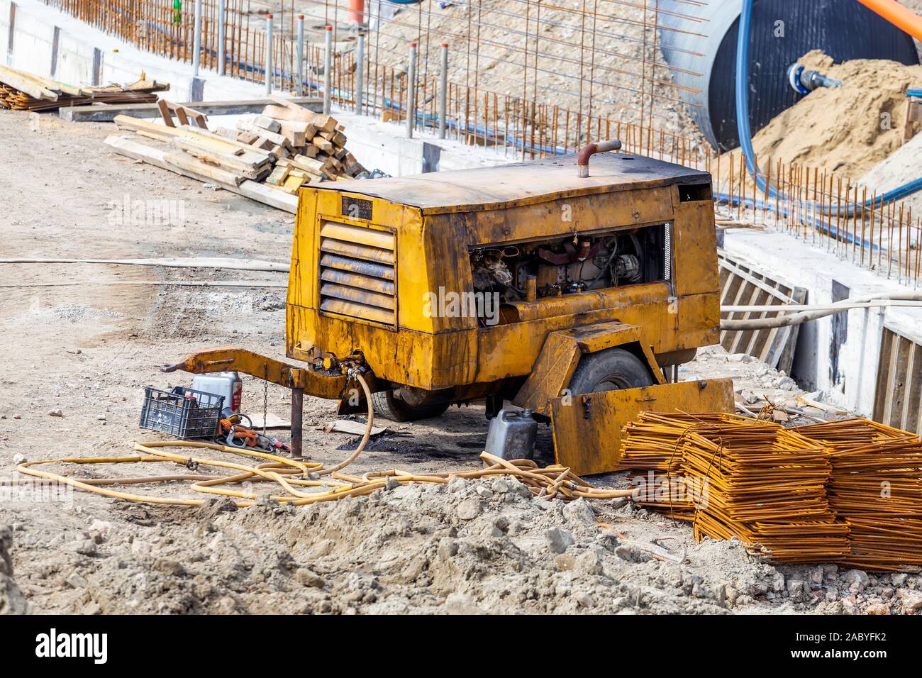 Old industrial diesel compressor for construction work at building site ...