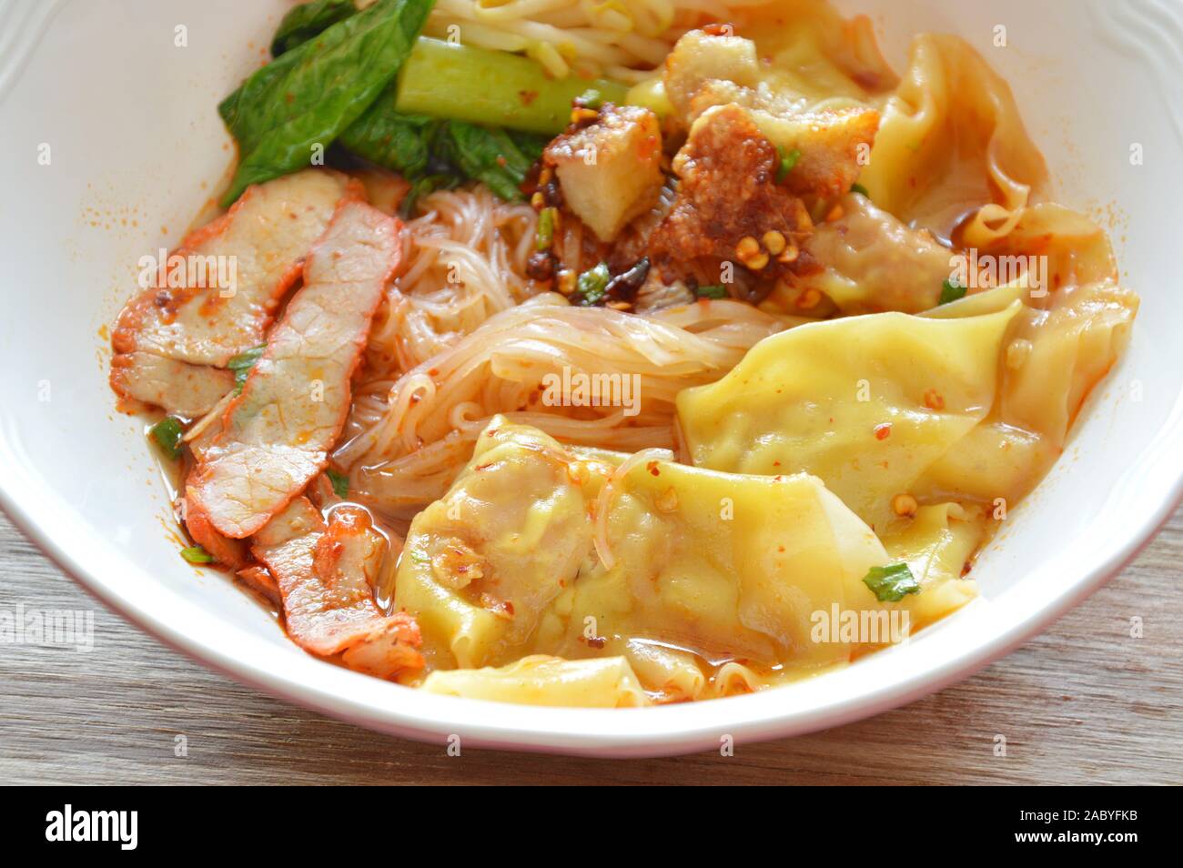 thin rice noodle topping dumpling and slice barbecue pork in soup Stock ...