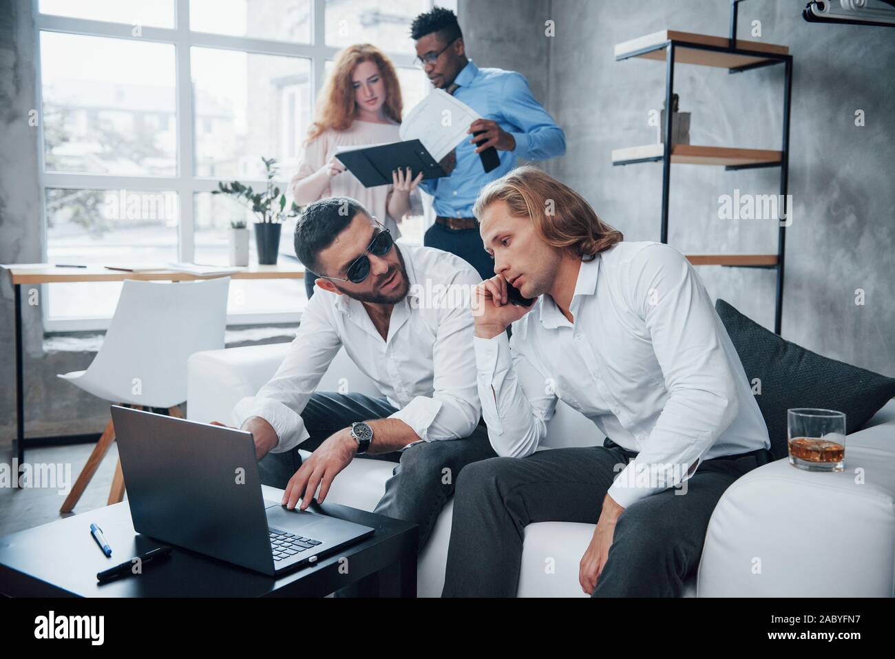 Everyone is busy. Group of multiracial office workers in formal clothes ...