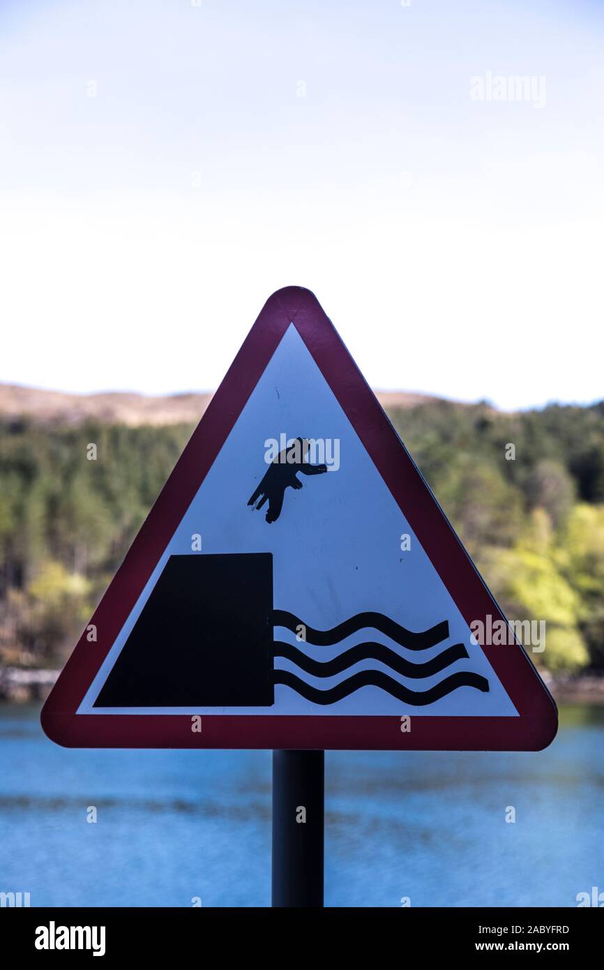 Sign warning of sudden drop near the water's edge, with an amusing ...