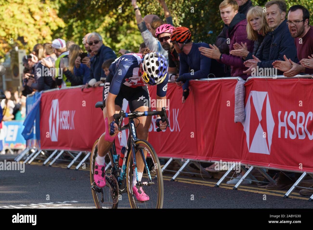 Spectators cheering on female cyclist from the U.S.A. racing in the ...