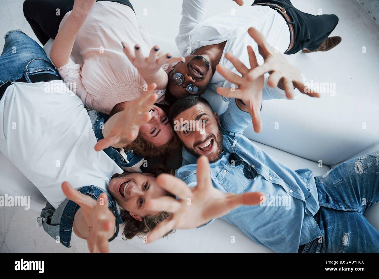 They want to reach you. Young people laying down and smiling to the ...