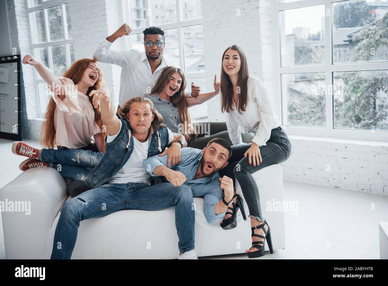 Smiling and getting mad. Cheerful young friends having fun in the white ...