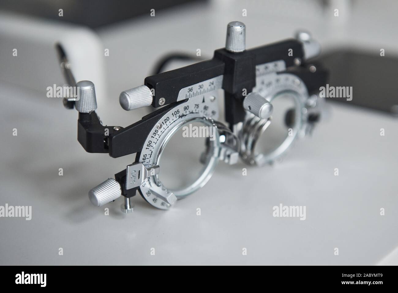 Focused detailed close up photo of phoropter standing on the white ...