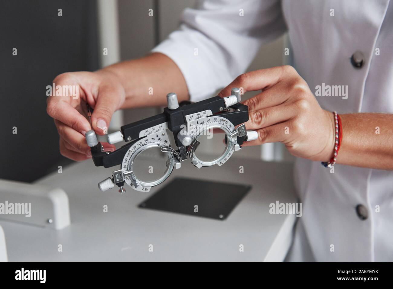Female hands holding the optical device for eye testing Stock Photo - Alamy
