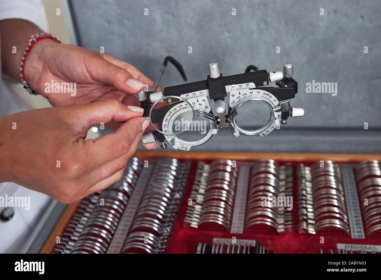 Doctor equipment. Female hands holding the optical device for eye ...