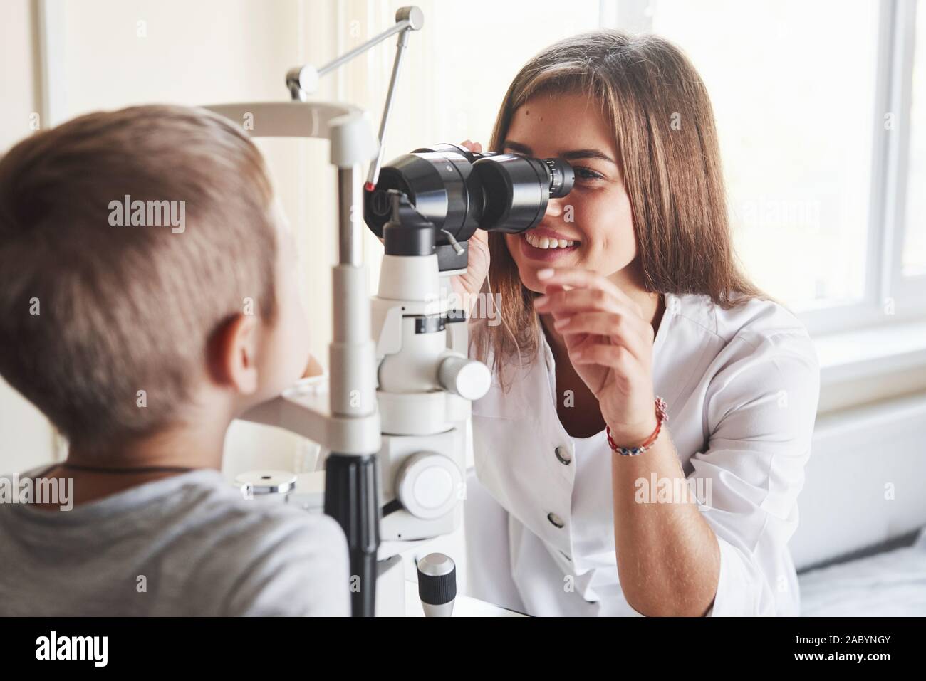 Tuning the device. Little boy having test for his eyes with special ...