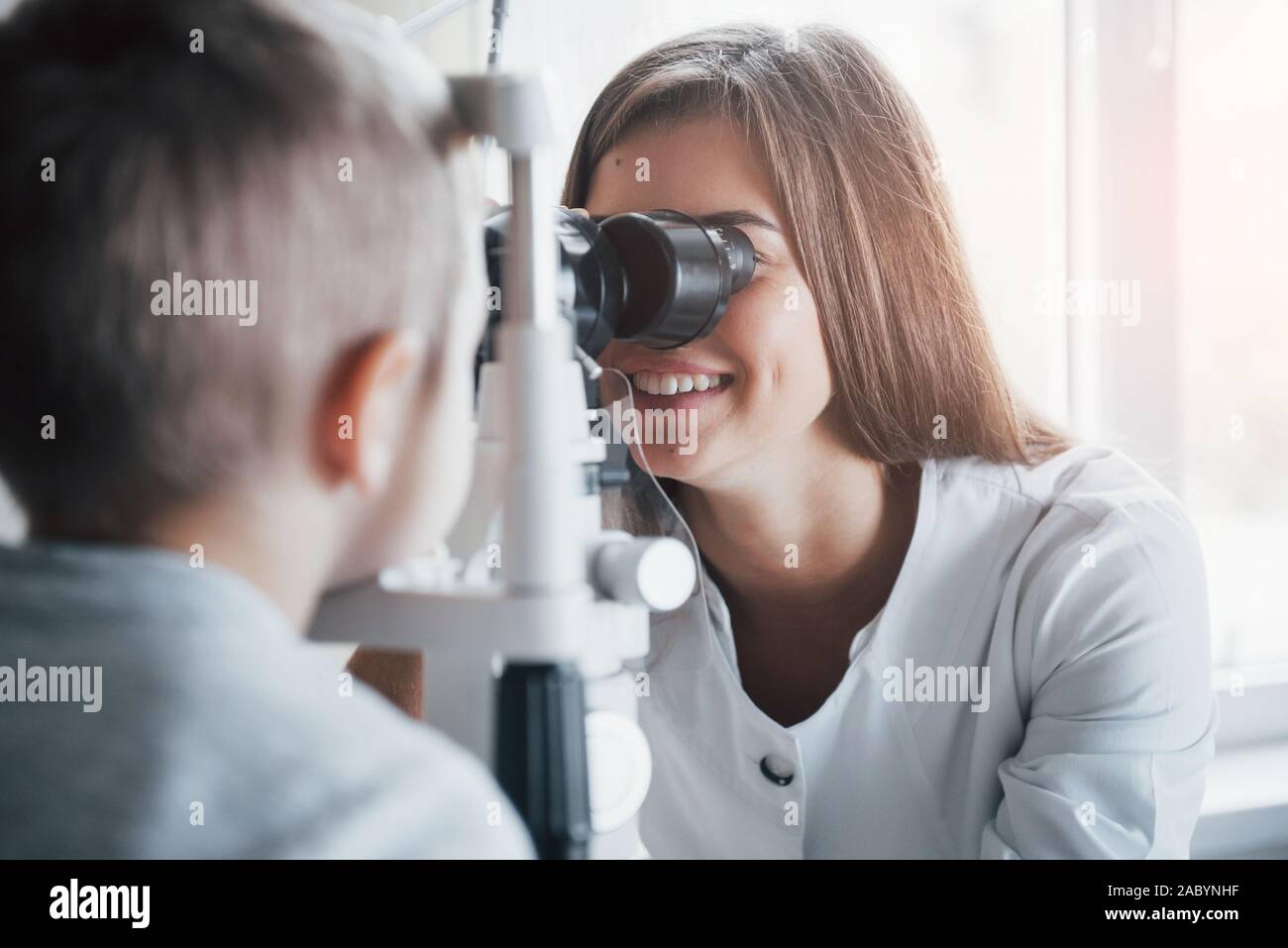 White light coming from the window. Little boy having test for his eyes ...