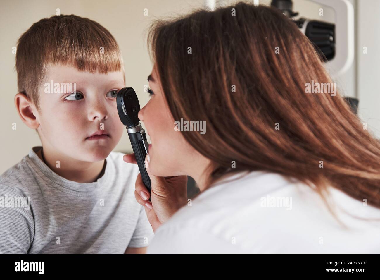 Boy have eye test with special little device. Concentrating on sight ...