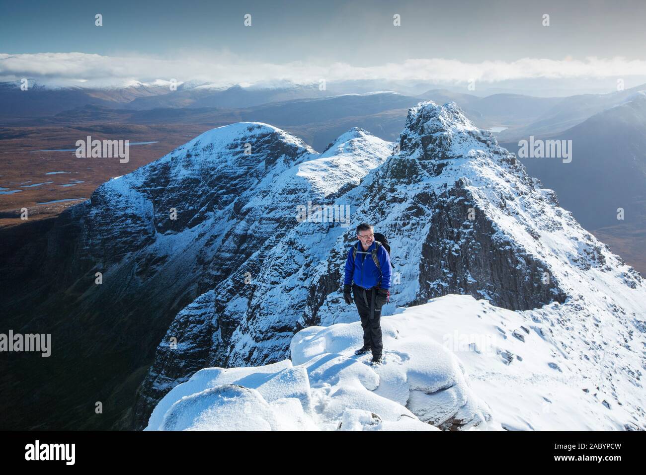 Mountaineer below Lord Berkeley's Seat on the Munro An Teallach, one of ...