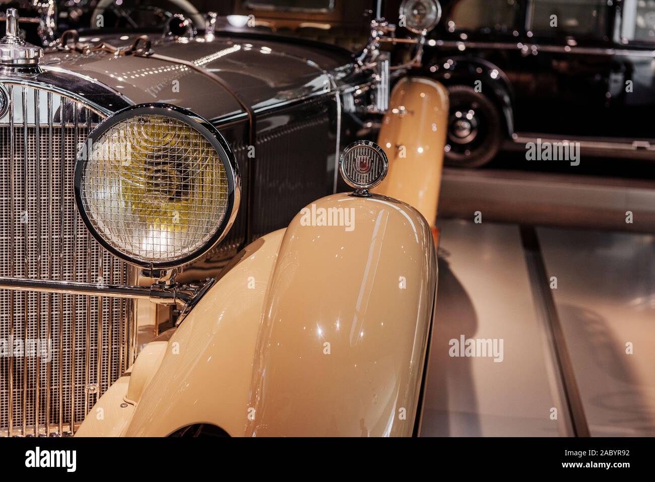 Front side view of part of the silvered yellow colored car with ...