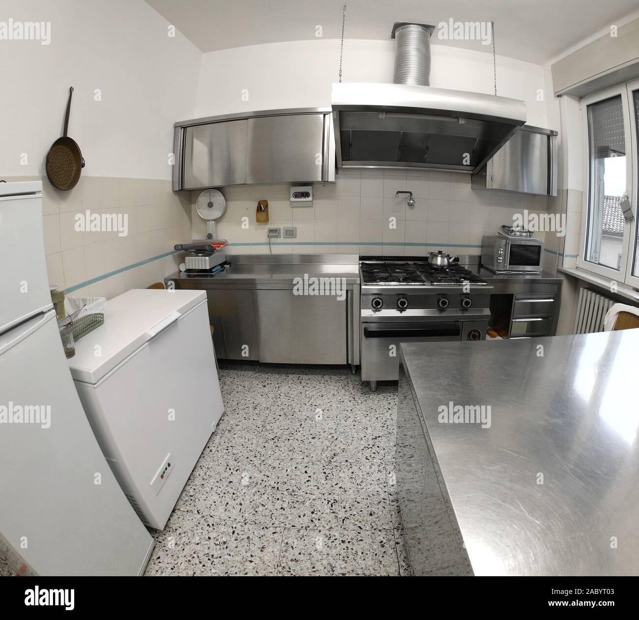Inside wide Kitchen with big stove in stainless steel Stock Photo - Alamy