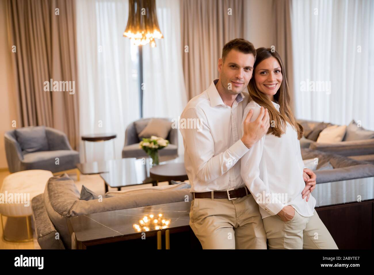 Embracing young couple relaxing in hi-res stock photography and images ...