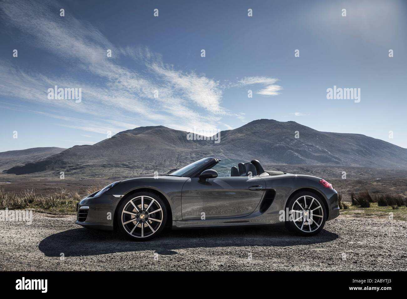 Porsche Boxster with an atmospheric backdrop of mountains in North West ...