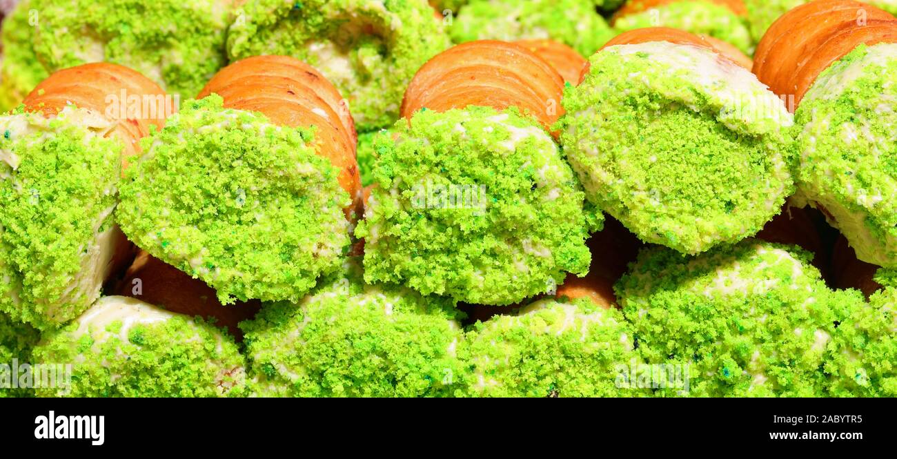 many pastries with green pistachios for sale at european pastry shop ...