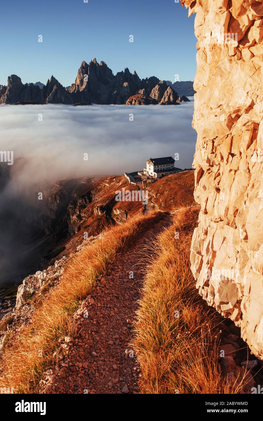 Hiking trail is filled with small pebbles with grass on the sides going ...