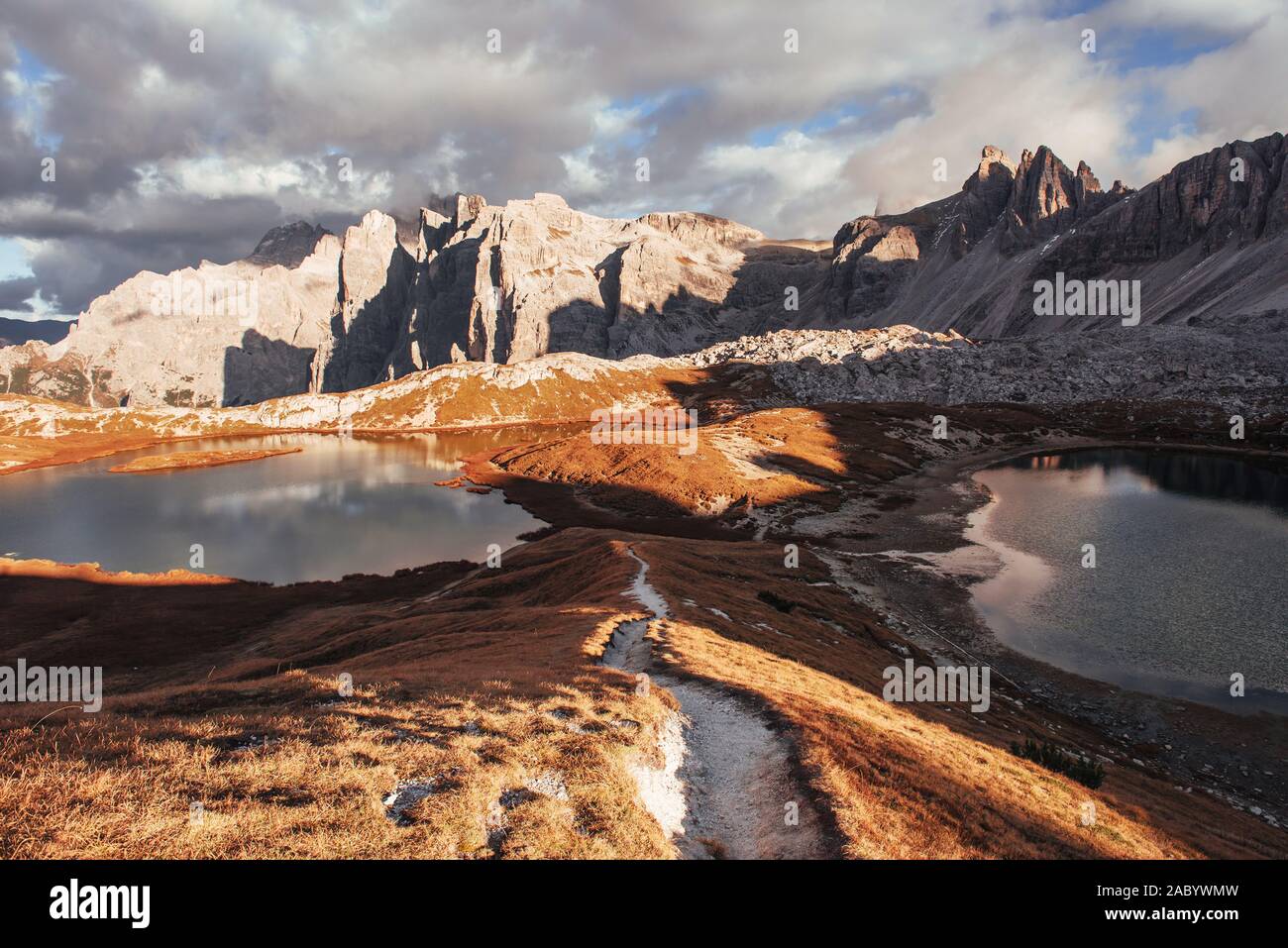 The path between two little lakes going to the great dolomite mountains ...