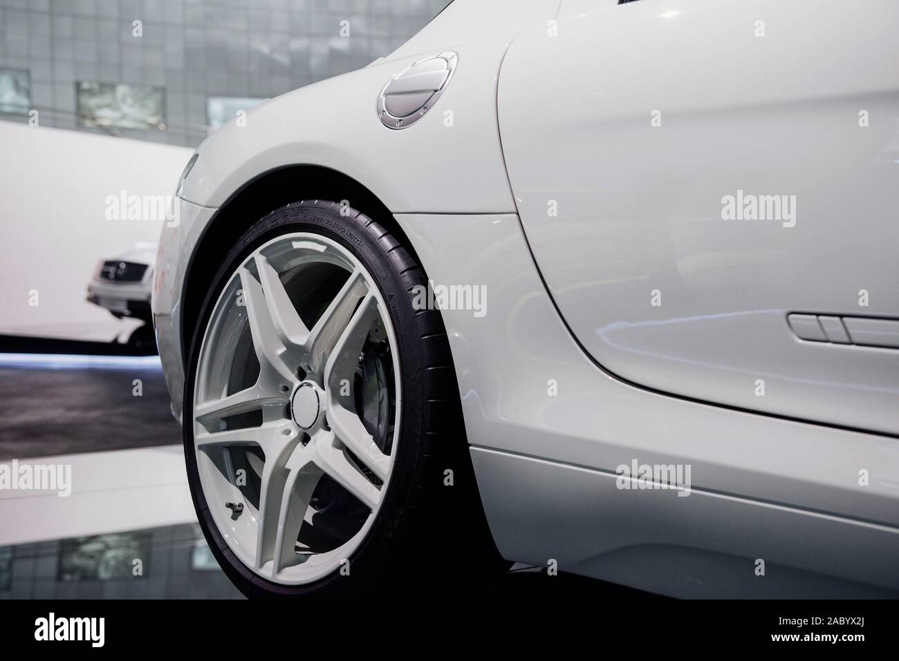 Side close up view of modern sport car with right white light alloy wheel and low-profile tire ...