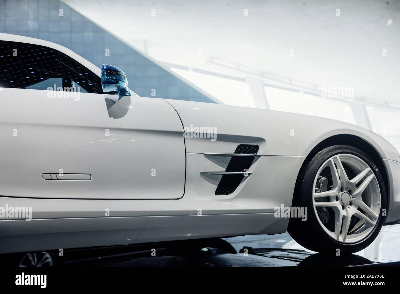 Side view of modern, fancy sport car with right blue mirror with turn ...