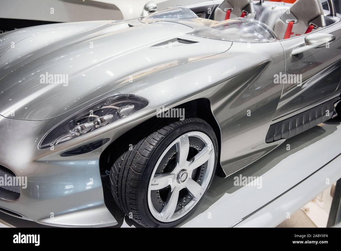 Front, side view of left headlight, mirror, chrome wheel disc of modern ...