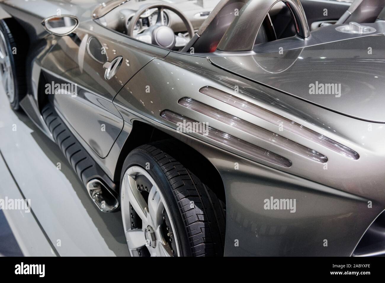 Side close up view from the back of modern roofless grey sport coupe ...