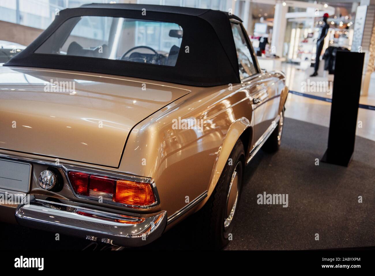Back and side view of beige retro cabriolet car with close up of right ...