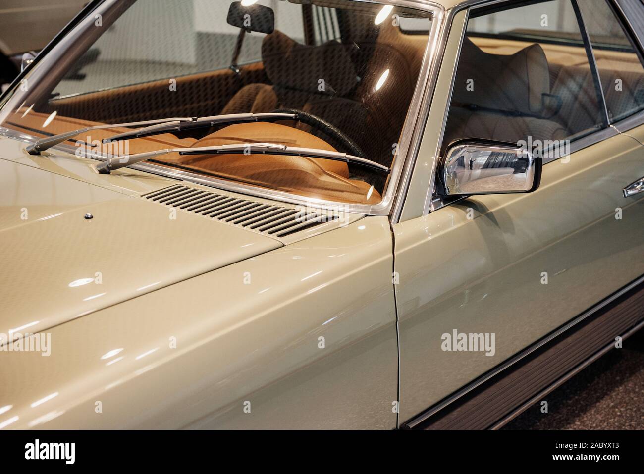 Side close up view of retro beige car with left chrome side mirror and ...