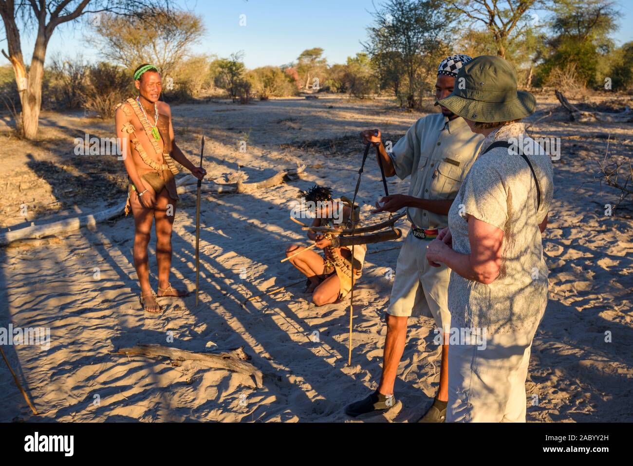 Tourist walk with San Bushmen at Meno a Kwena camp, Kalahari, Botswana ...