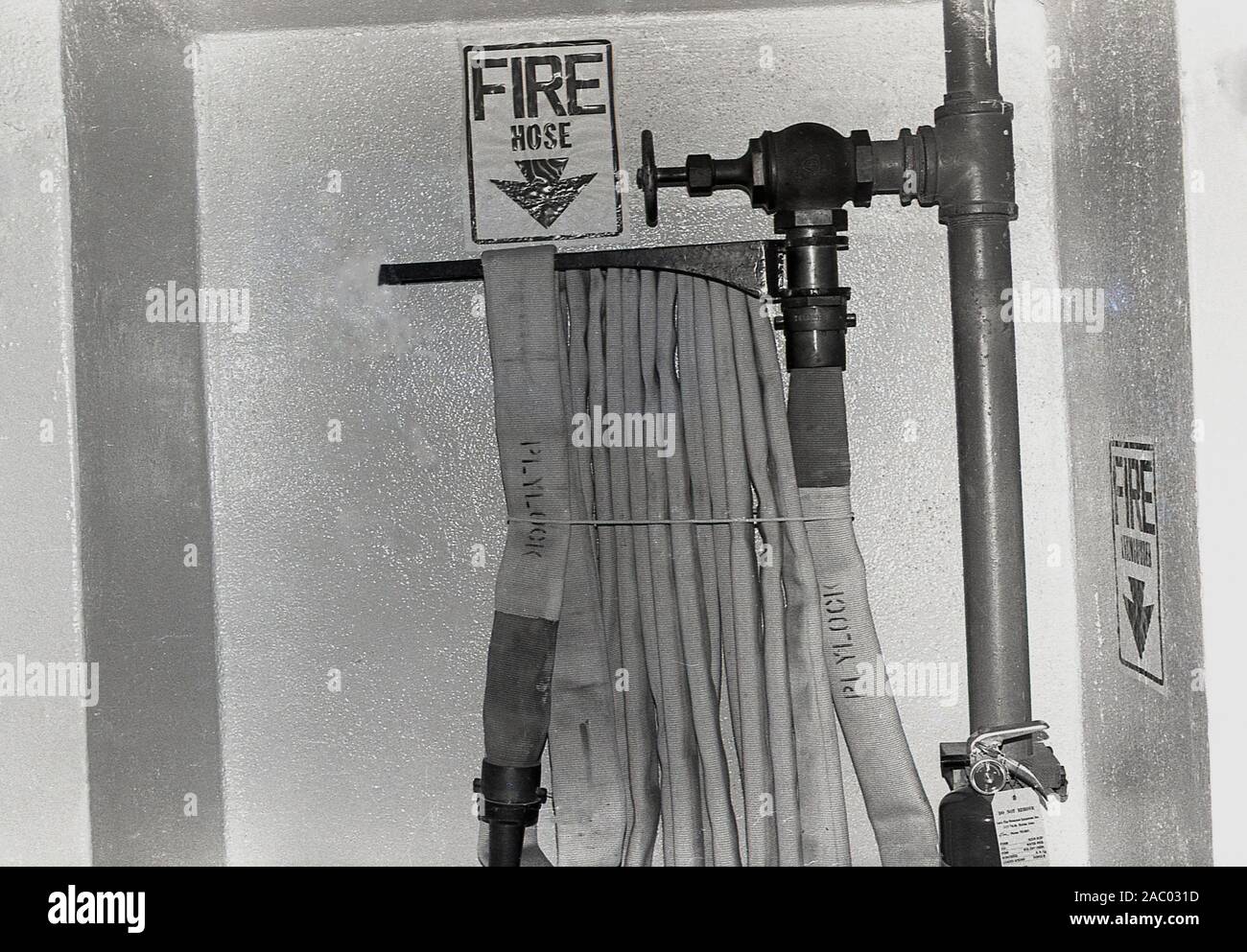 1960s, historical, traditional fire hose on a wall in an American high ...
