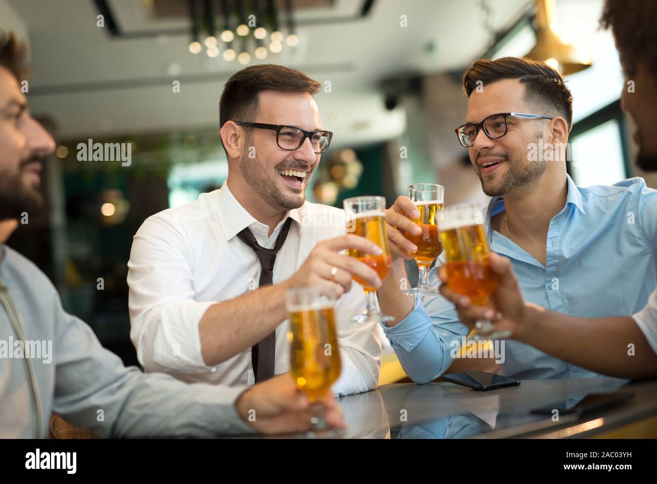 Businessmen sit in pub and drinking beer after work Stock Photo - Alamy