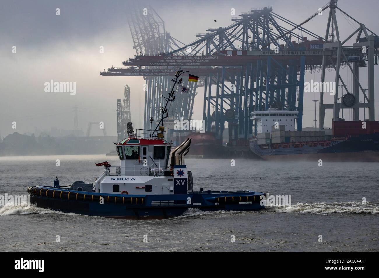 Container Terminal Tollerort in the Port of Hamburg, fog, container ship being loaded and ...