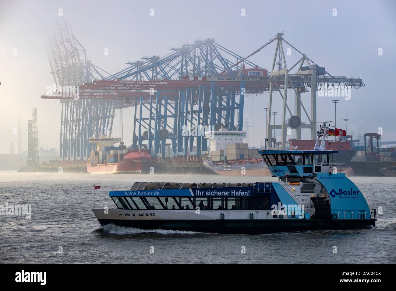 Container Terminal Tollerort in the Port of Hamburg, fog, container ship being loaded and ...