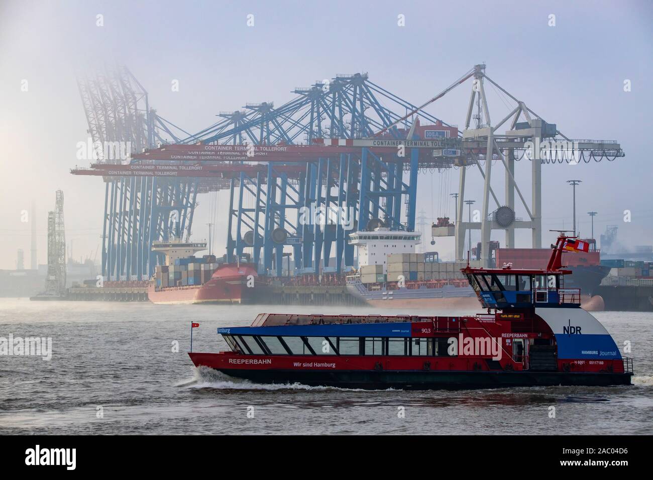 Container Terminal Tollerort in the Port of Hamburg, fog, container ship being loaded and ...