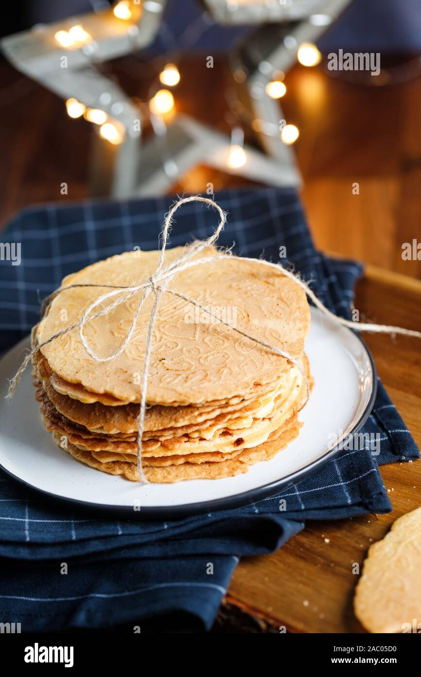 Stack of Norwegian crispy round waffles Krumkake on a tray. Concept of ...