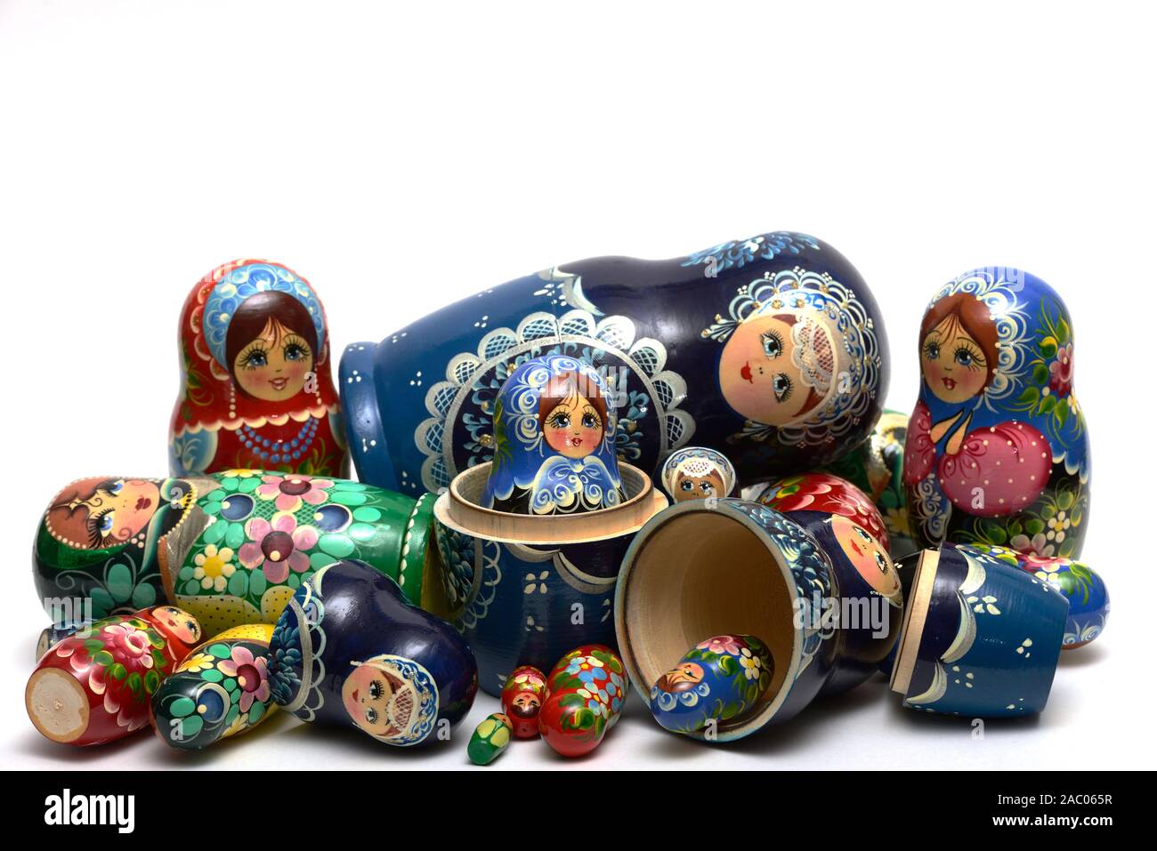 traditional Russian nesting dolls scattered in a mess on a white ...