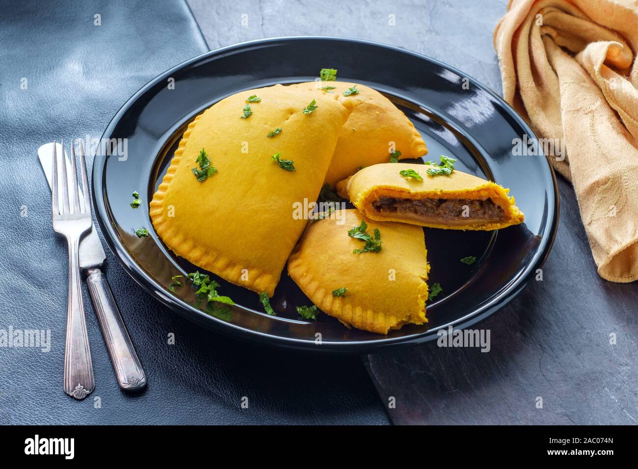 Spicy Jamaican beef turnovers with mint garnish Stock Photo - Alamy