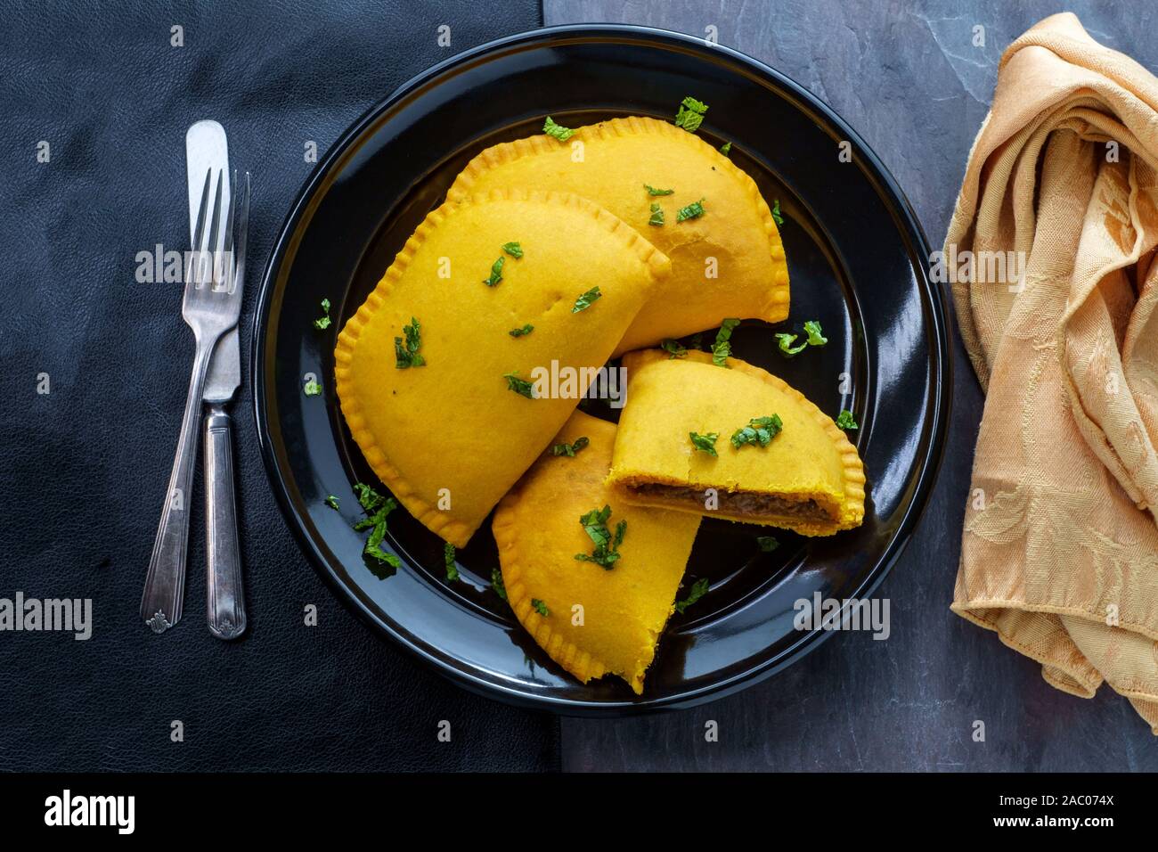 Spicy Jamaican beef turnovers with mint garnish Stock Photo - Alamy