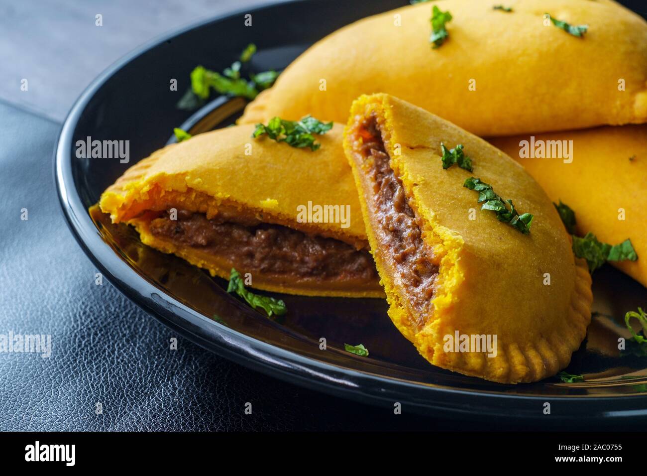 Spicy Jamaican beef turnovers with mint garnish Stock Photo - Alamy