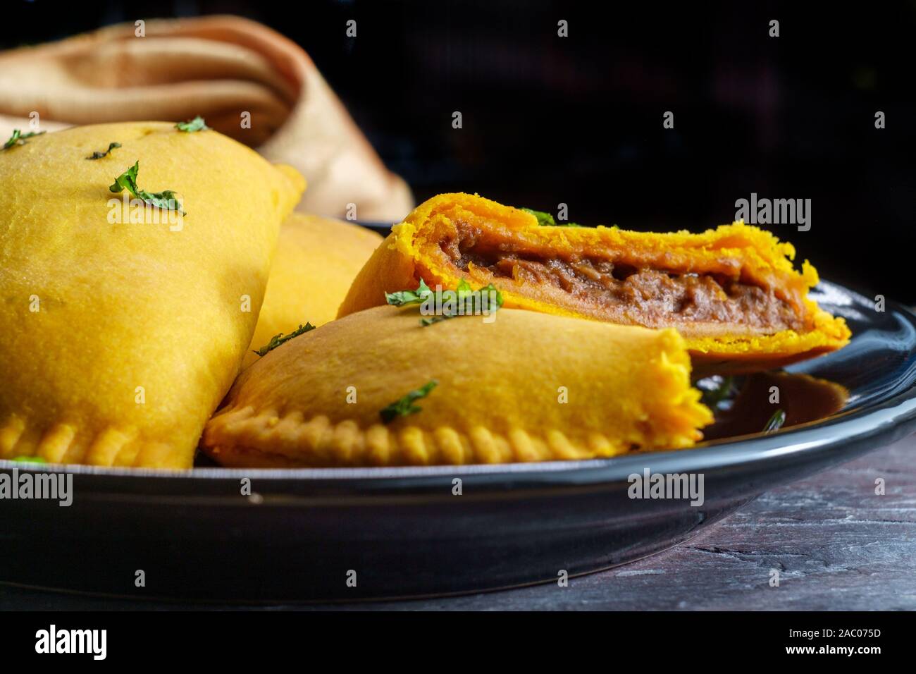 Spicy Jamaican beef turnovers with mint garnish Stock Photo - Alamy