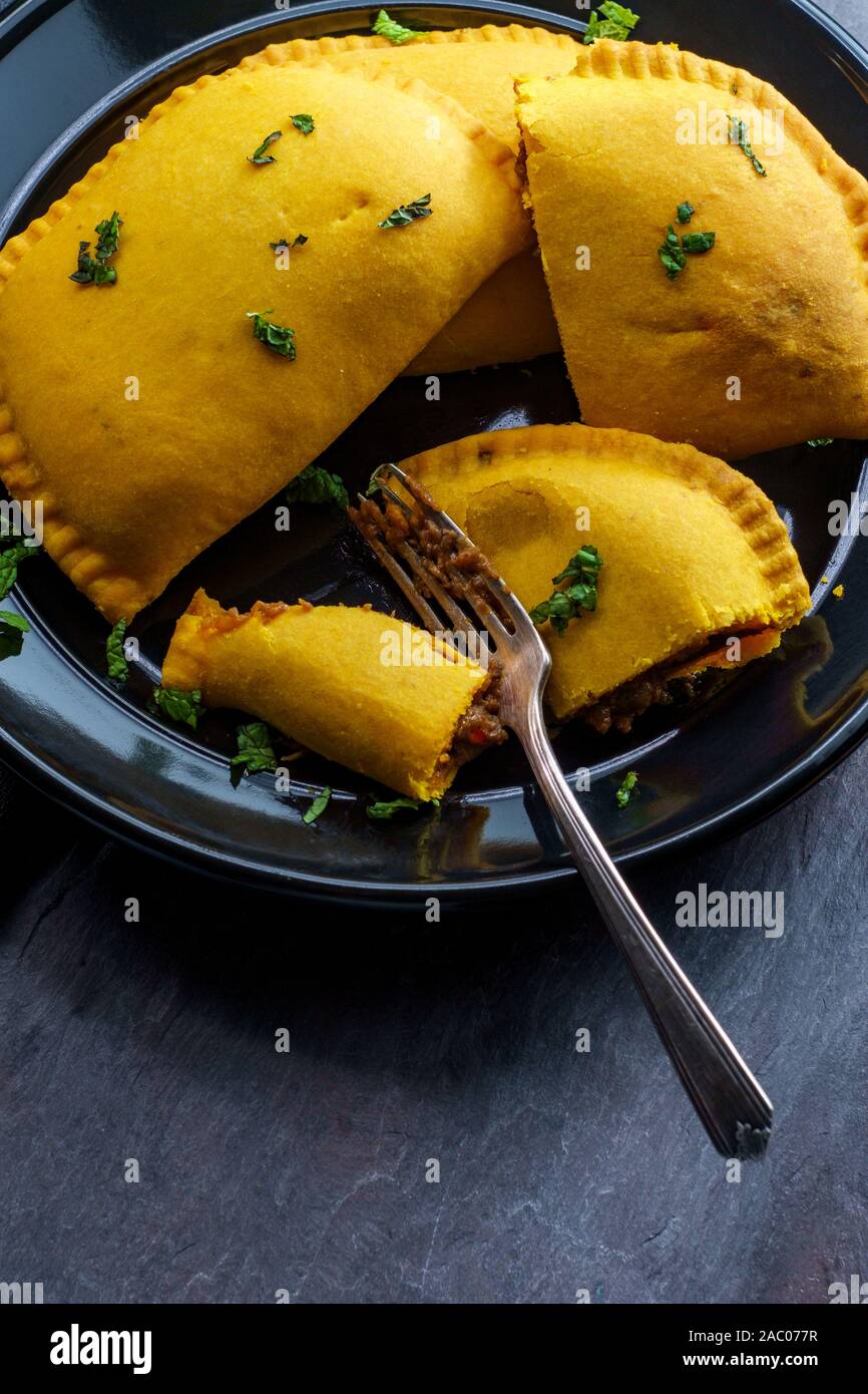 Spicy Jamaican beef turnovers with mint garnish Stock Photo - Alamy