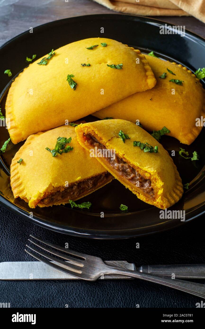 Spicy Jamaican beef turnovers with mint garnish Stock Photo - Alamy