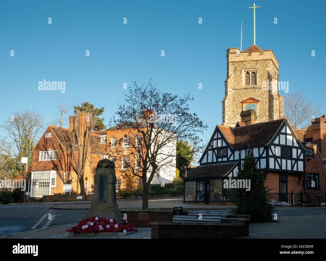 War Memorial with wreaths of red poppies laid at the foot, with ...